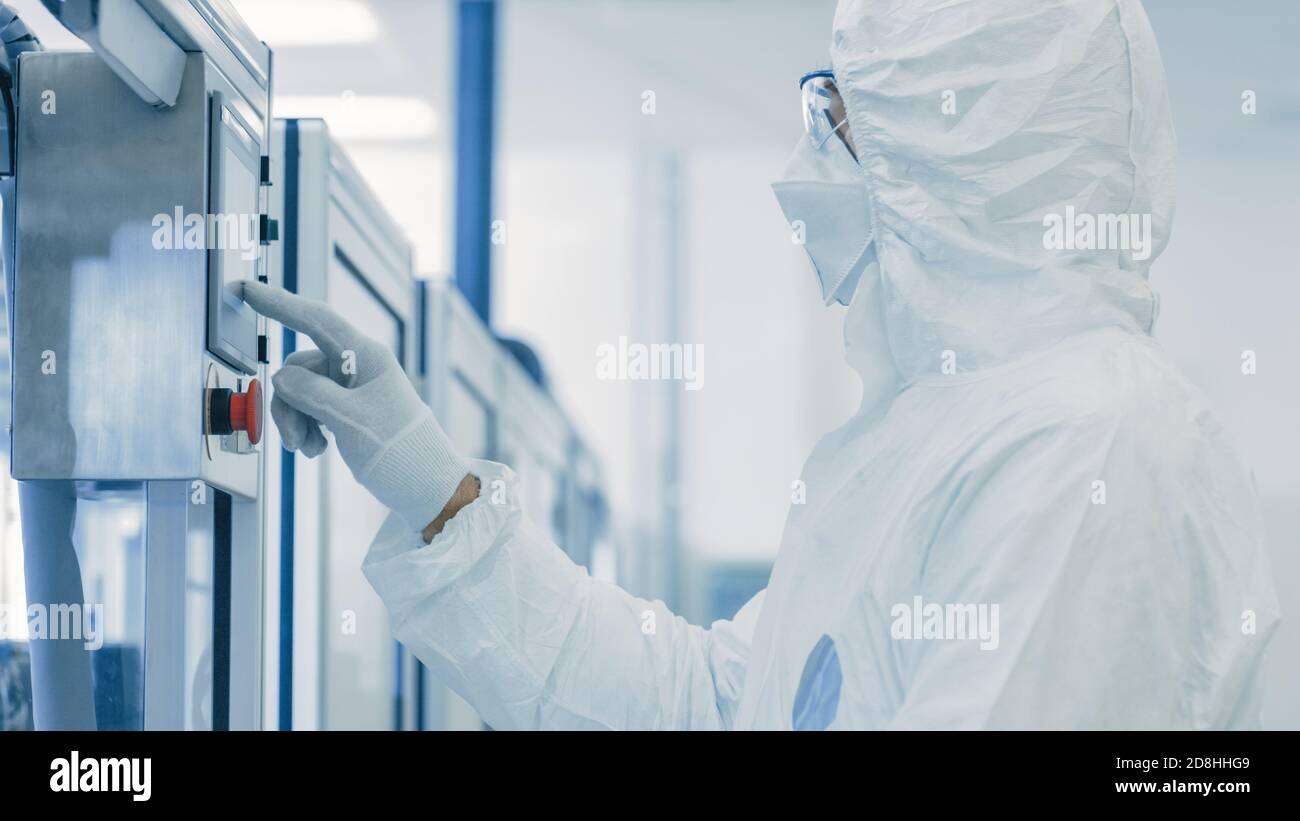 In Manufacturing Facility Scientist Wearing Sterile Protective Coverall ...