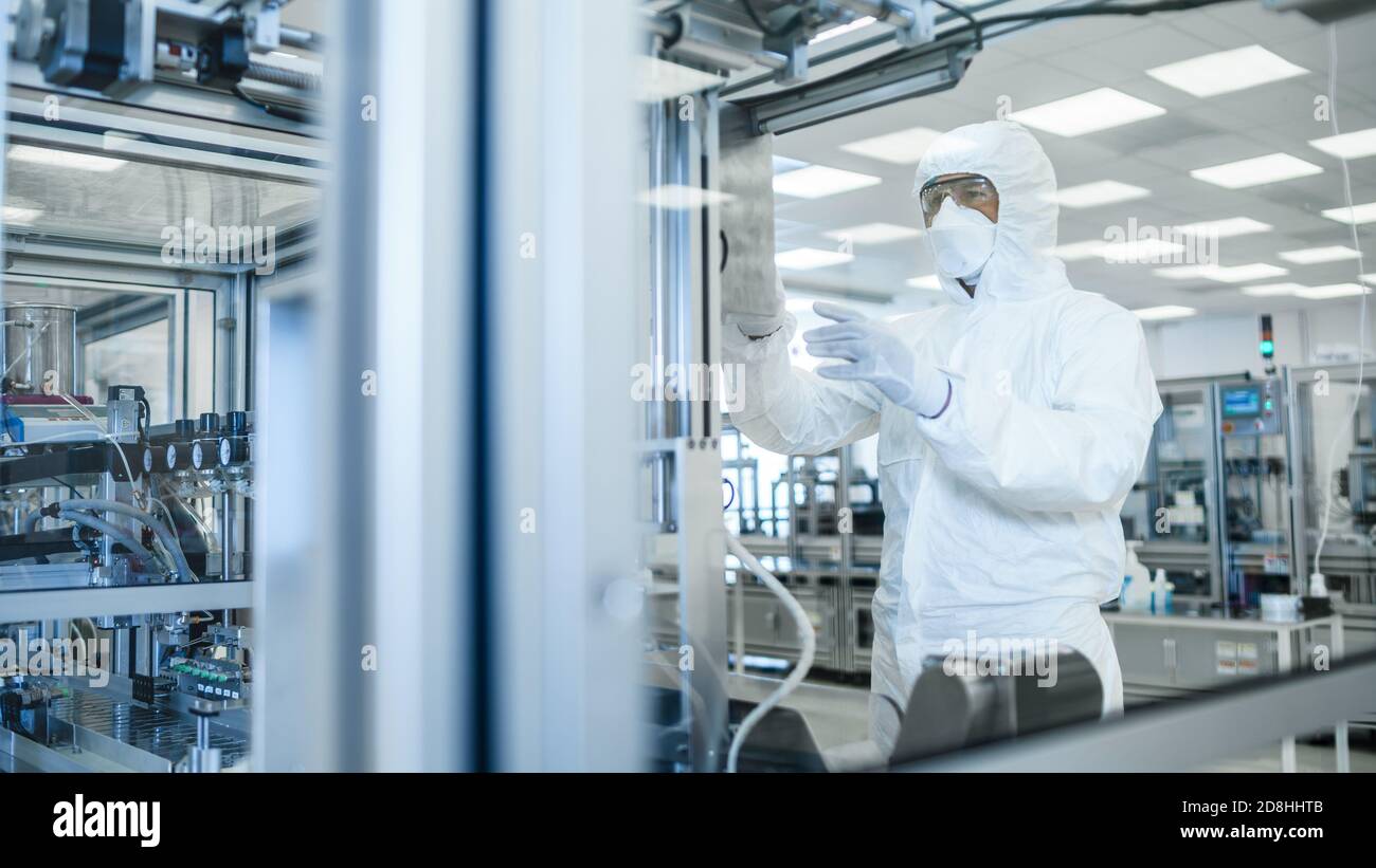 In the Manufacturing Facility Shot of Scientist in Sterile Protective ...