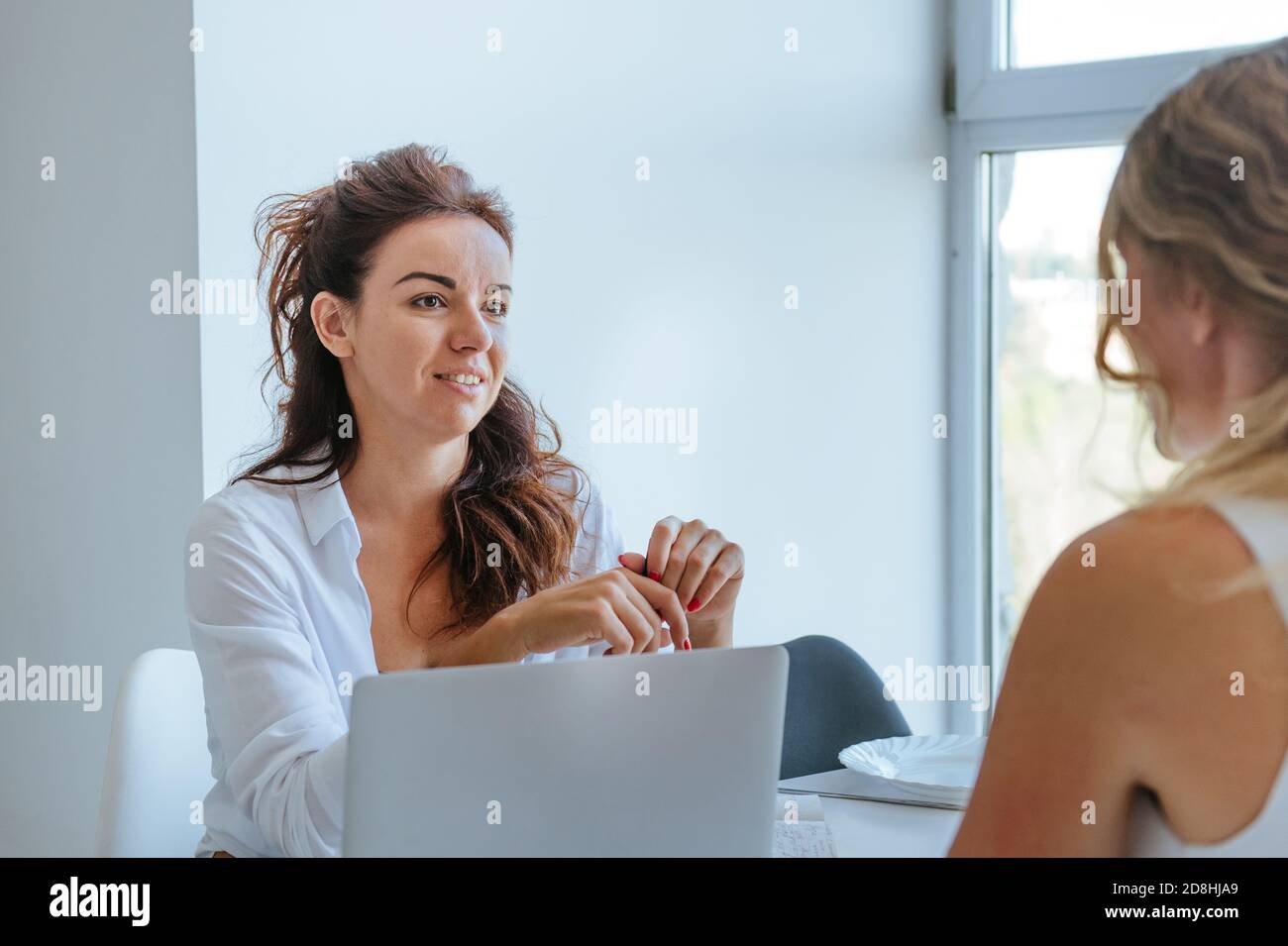 Female coach is consulting young woman Stock Photo - Alamy