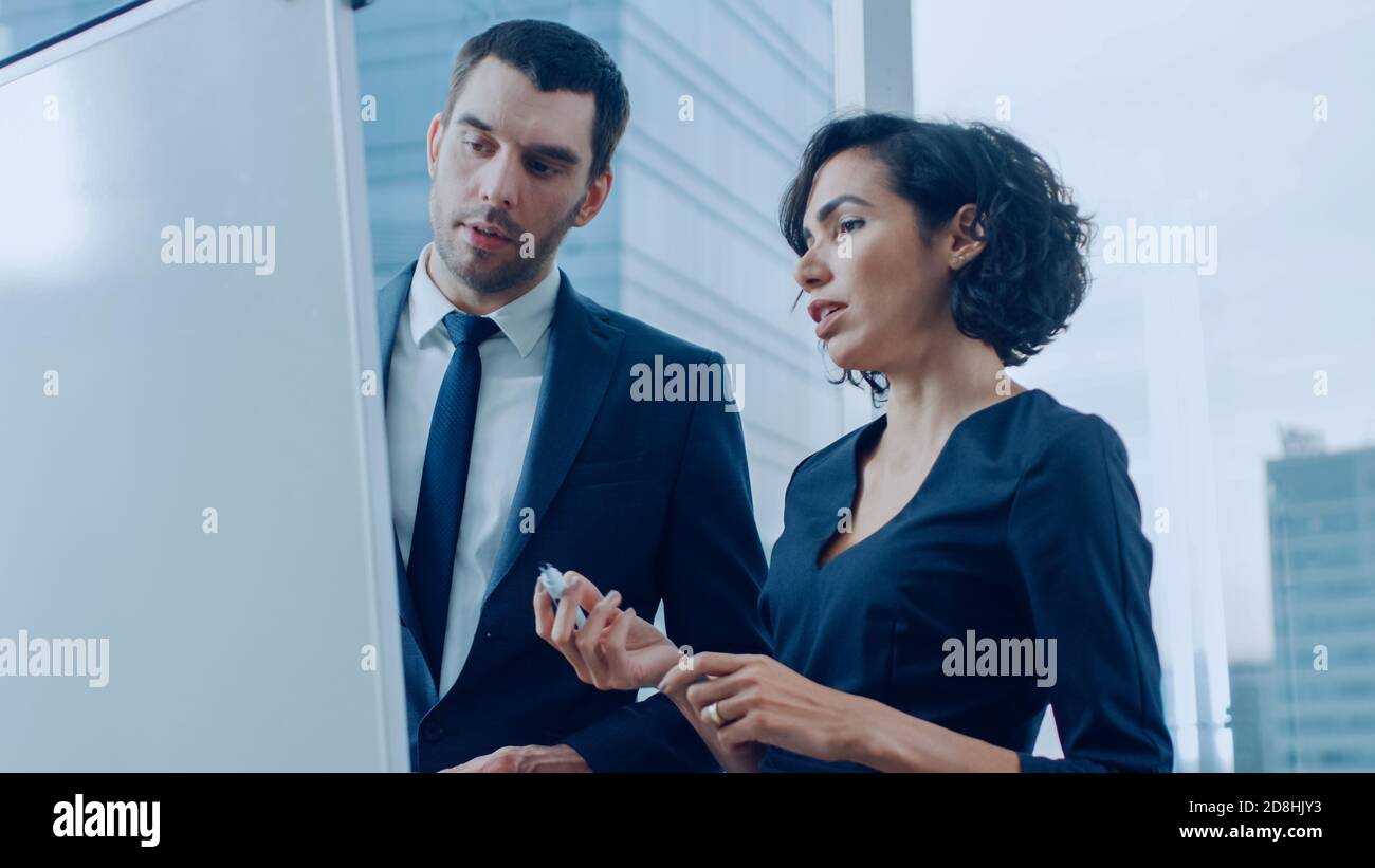 In the Office Handsome Businessman and Beautiful Businesswoman Have ...