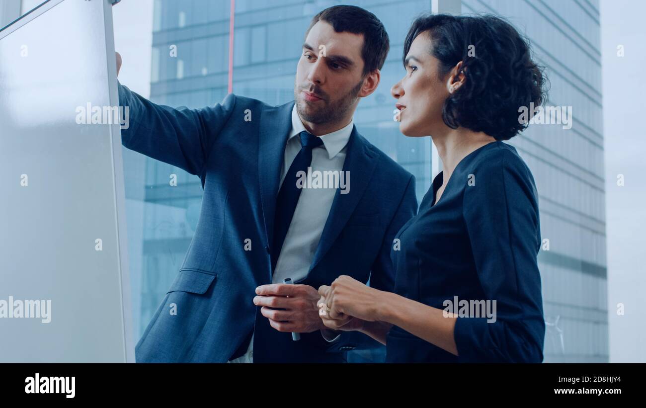 In the Office Handsome Businessman and Beautiful Businesswoman Have ...