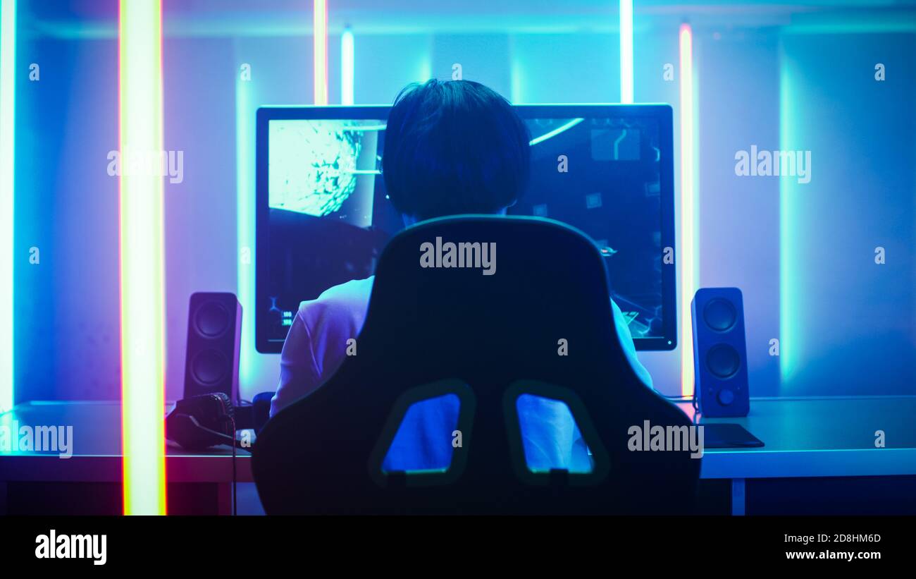 Back View Shot of the Professional Gamer Playing in First-Person ...