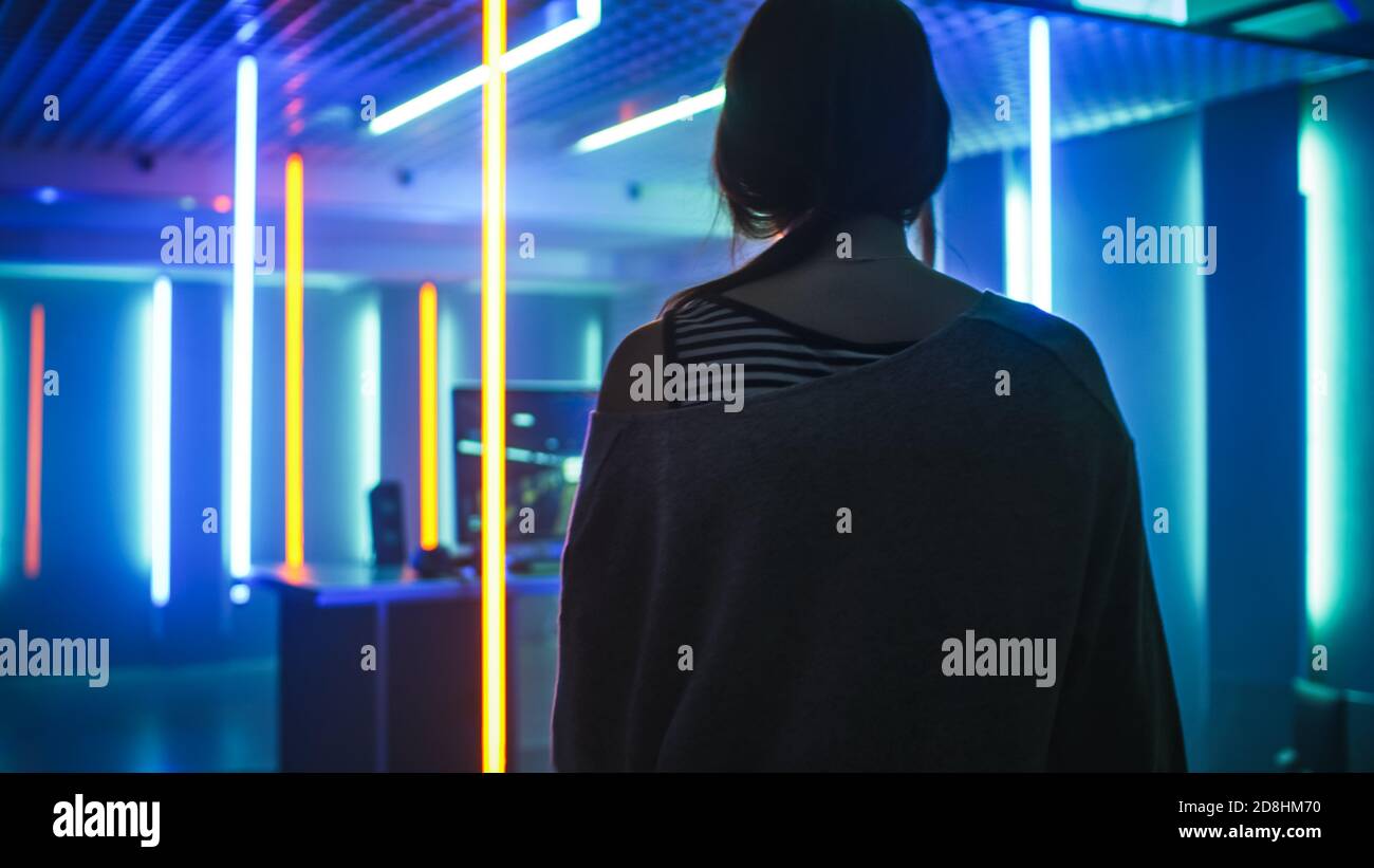 Back View Shot of the Beautiful Professional Gamer Girl Looking at Her ...