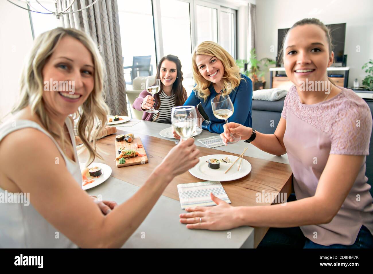 A Group of attractive mature people eating sushi at home Stock Photo ...