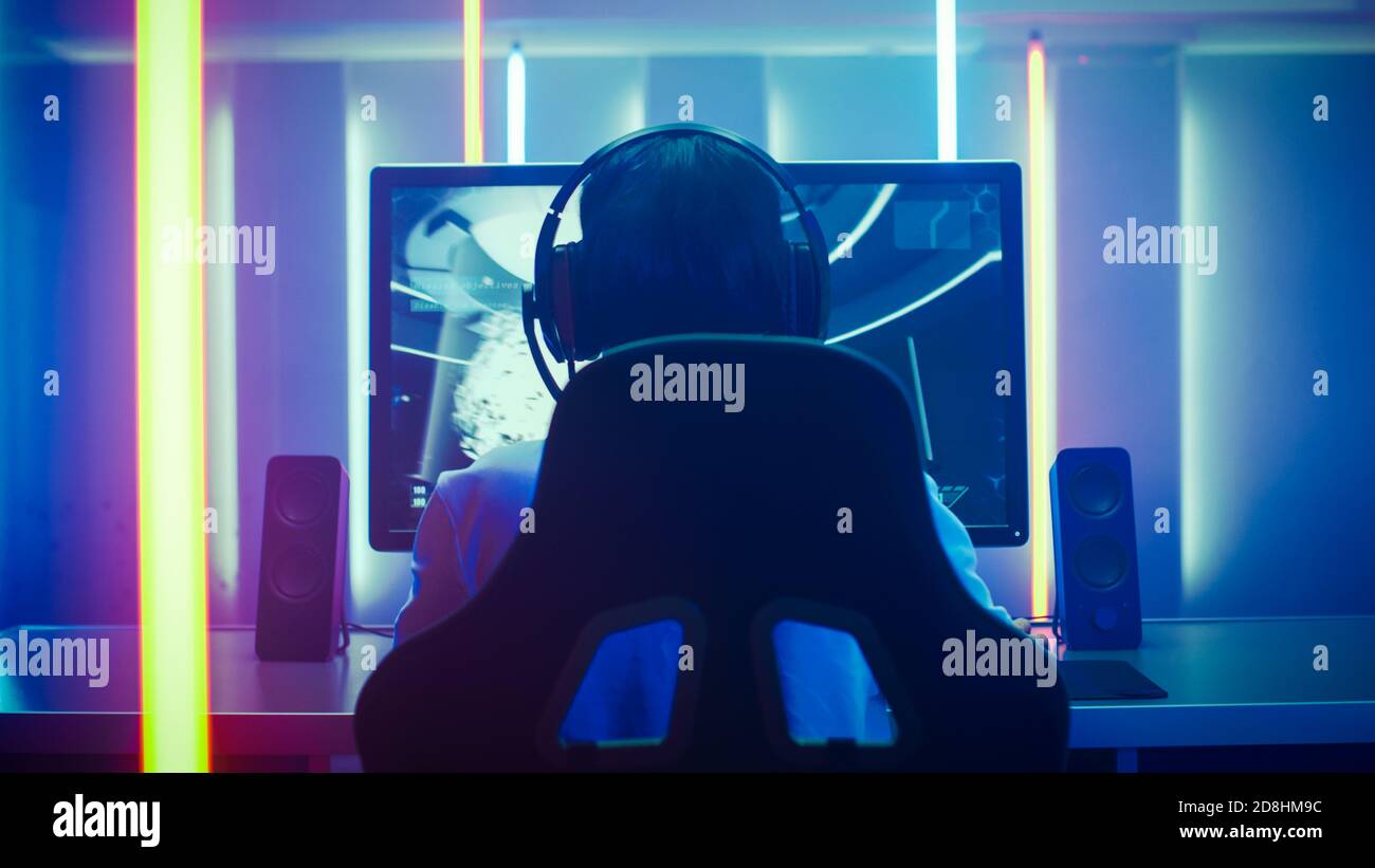 Back View Shot of the Professional Gamer Playing in First-Person ...