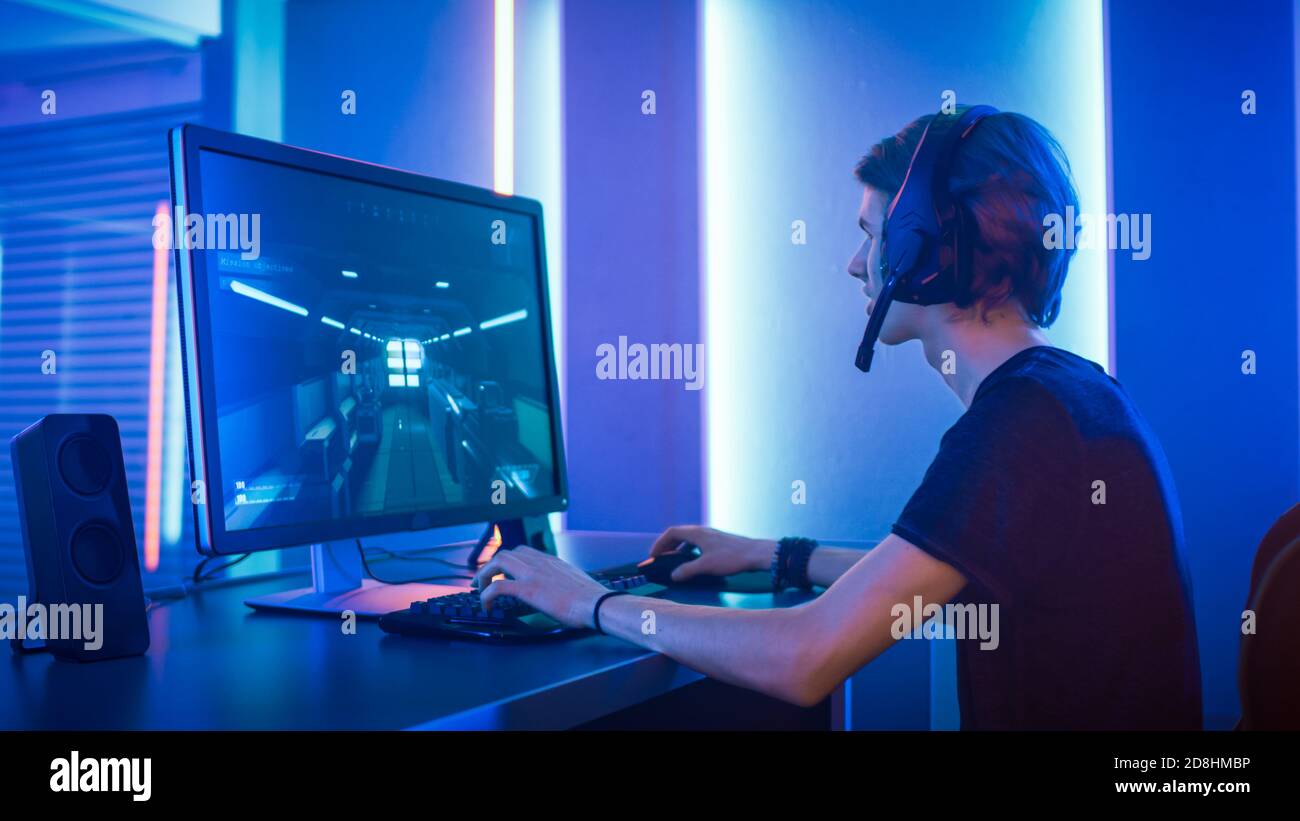 Shot of the Professional Gamer Playing in First-Person Shooter Online ...