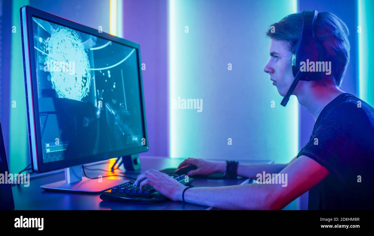 Shot of the Professional Gamer Playing in First-Person Shooter Online ...