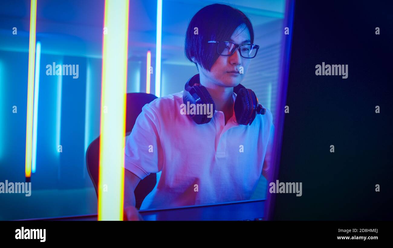 Professional East Asian Gamer Playing in Online Video Game on His ...