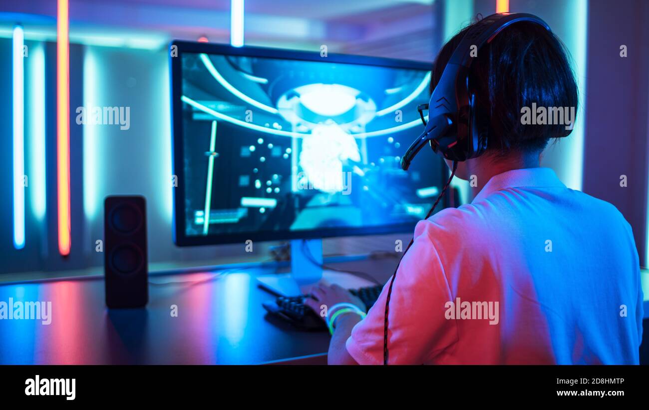 Back View of Professional Gamer Playing in First-Person Shooter Online ...