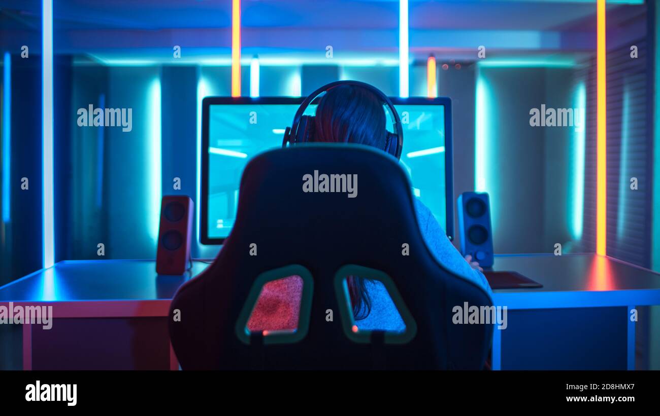 Back View of Professional Gamer Playing in First-Person Shooter Online ...