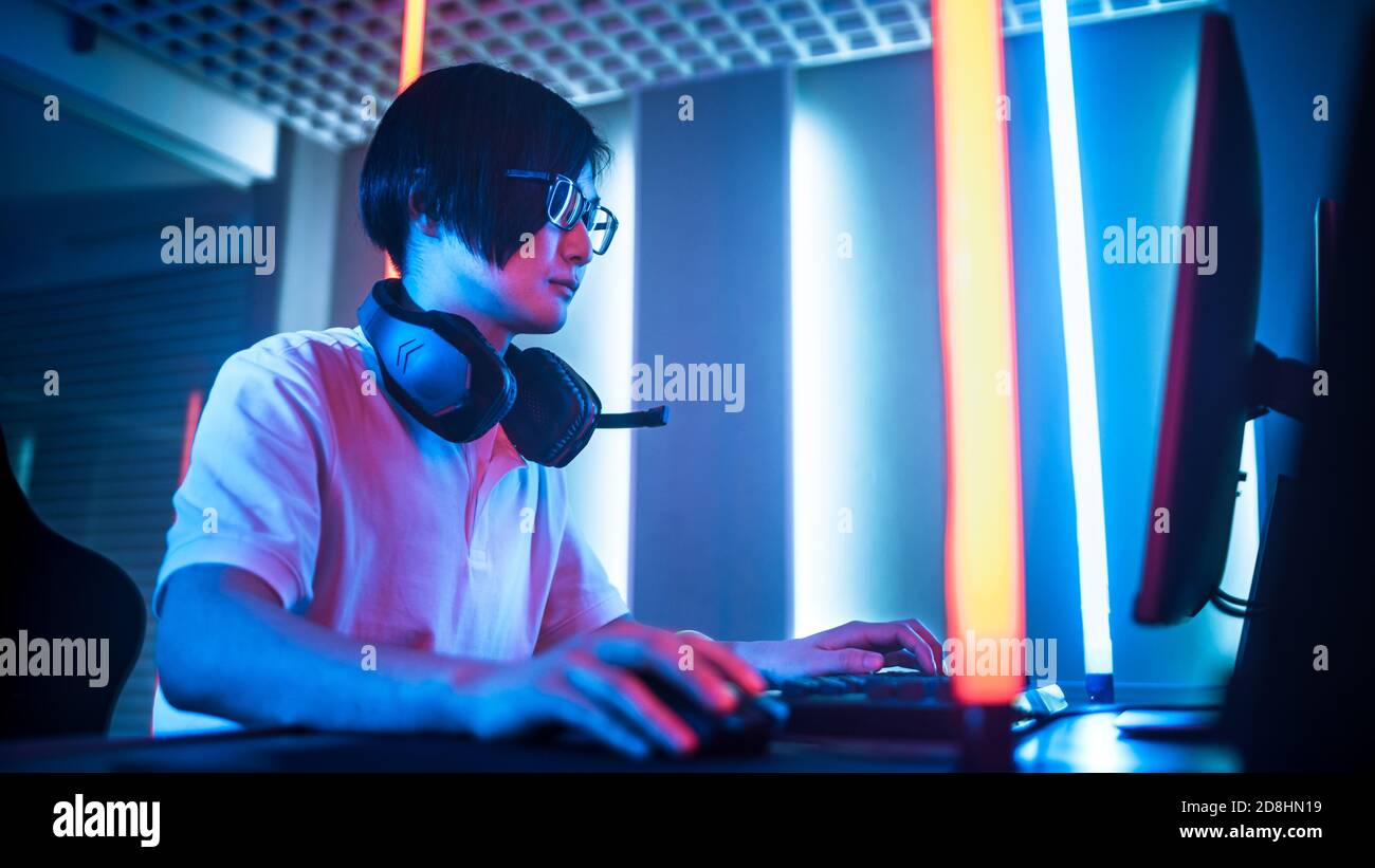 Low Angle Shot of a Professional East Asian Gamer Playing in Online ...
