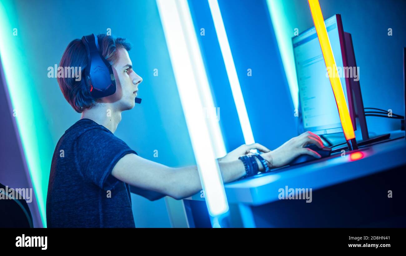 Dutch Angle of a Young Pro Gamer Playing in Online Video Game, talks ...