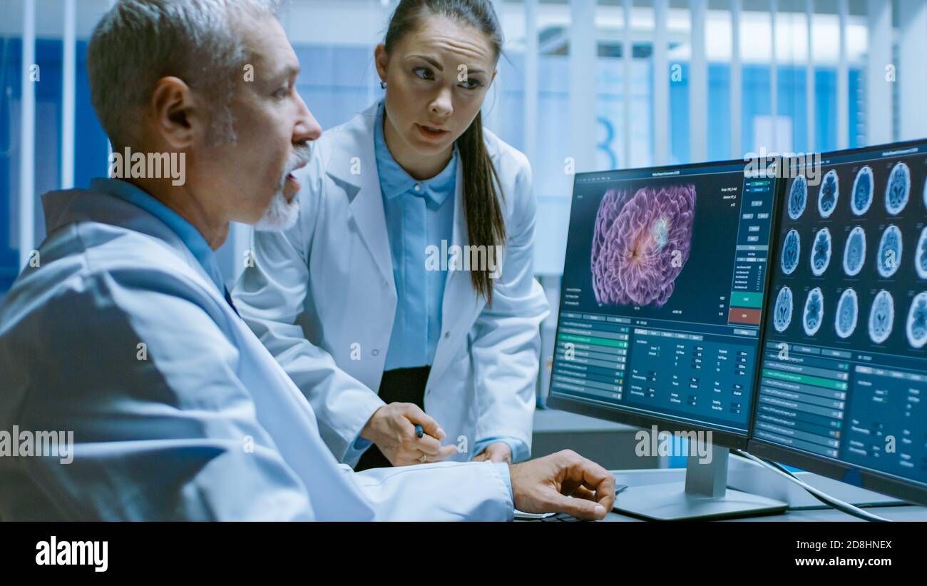 Two Medical Scientists in the Brain Research Laboratory Discussing ...