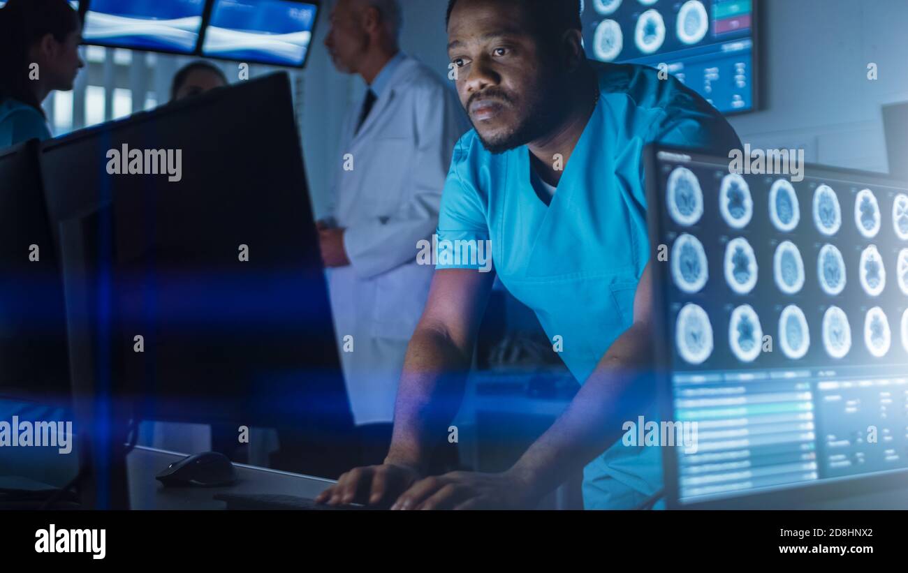 Male Scientist Neurologist Working on a Personal Computer in Modern ...
