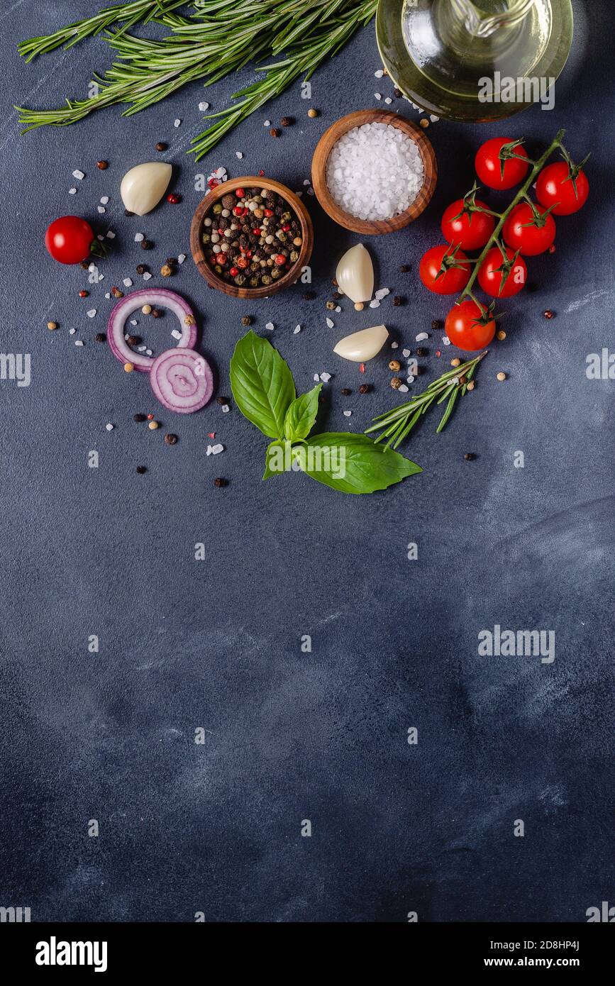 Herbs and condiments on black stone background. Top view with copy ...