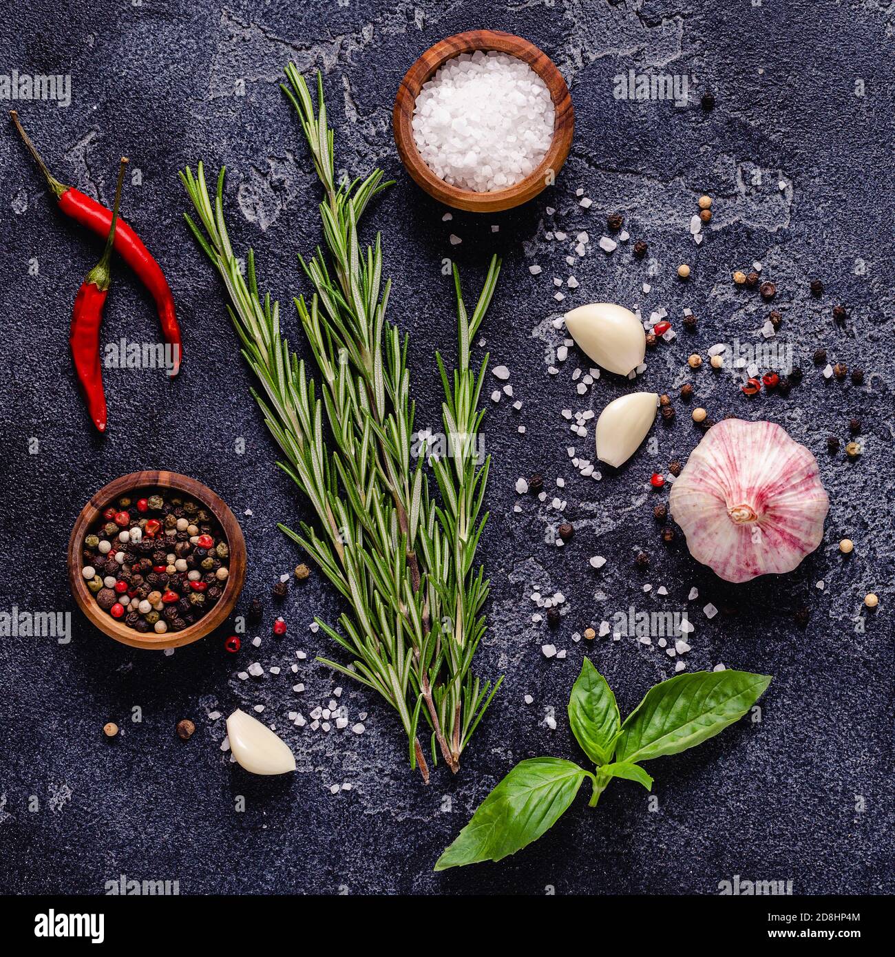 Herbs and condiments on black stone background. Top view with copy ...