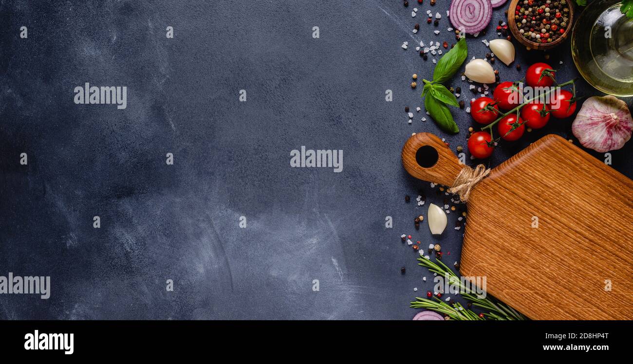 Herbs and condiments on black stone background. Top view with copy ...
