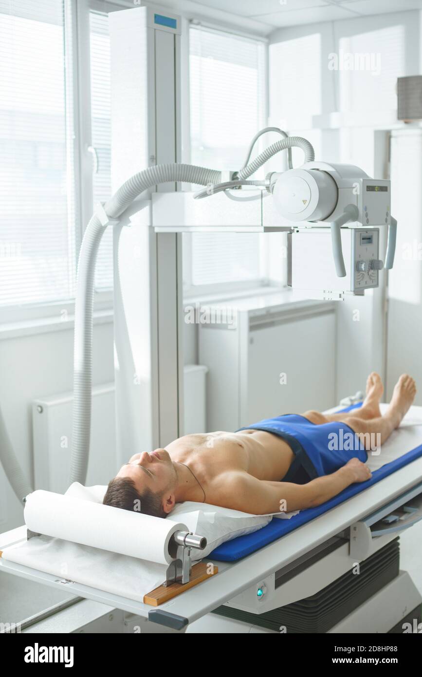 In the Hospital, Man Lying in Bed during X-Ray Machine Scanning ...