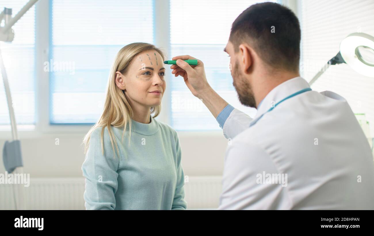Over the Shoulder Shot of a Plastic Cosmetic Surgeon Draws Lines on a ...