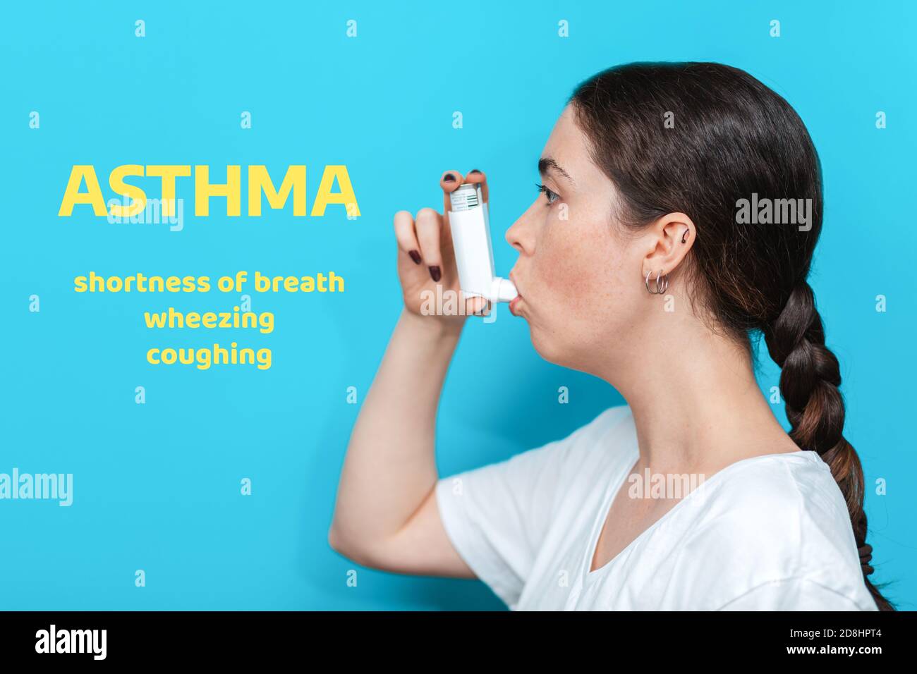 Symptoms of asthma. Portrait of a young woman using an inhaler. Blue ...