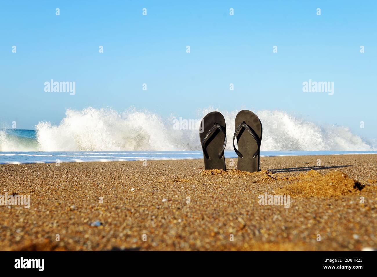 Flip-flops on the beach against a beautiful wave Stock Photo - Alamy