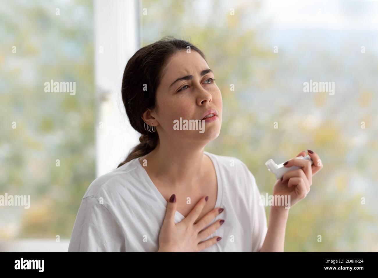 Allergic Asthma. Portrait of a woman holding an inhaler with medicine ...