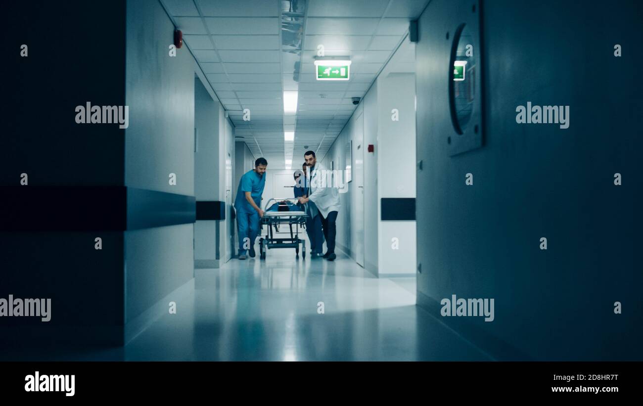 Emergency Department: Doctors, Nurses and Surgeons Push Gurney ...