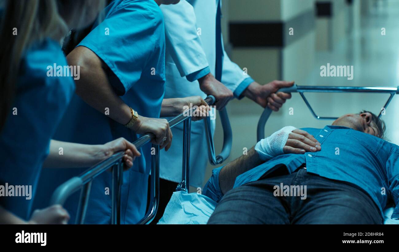 Emergency Department: Doctors, Nurses and Surgeons Push Gurney ...