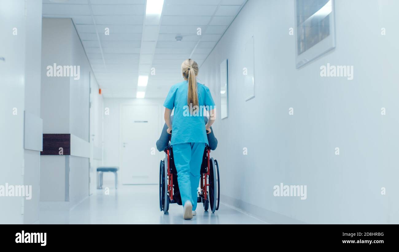 Hospital staff moving through hallway hi-res stock photography and ...