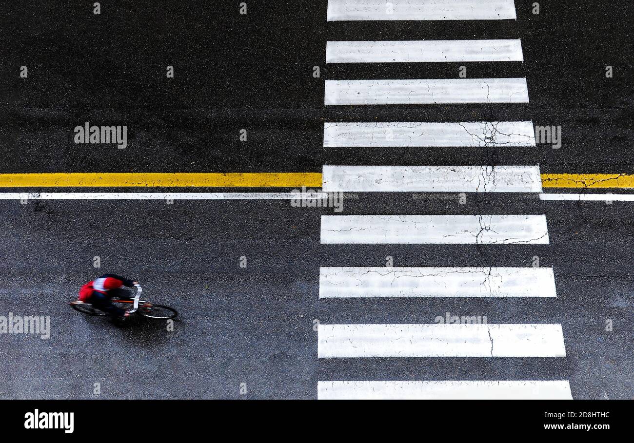 Top view of gentleman cyclist riding on bike down the street near ...