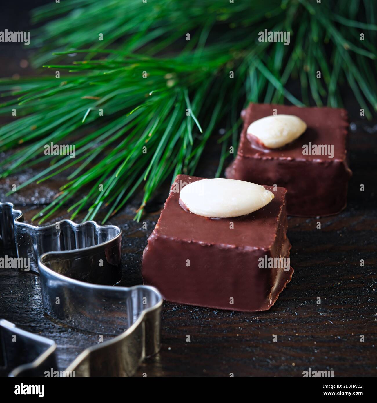 Marzipancubes with chocolate icing on a black cooling grid, decorated ...