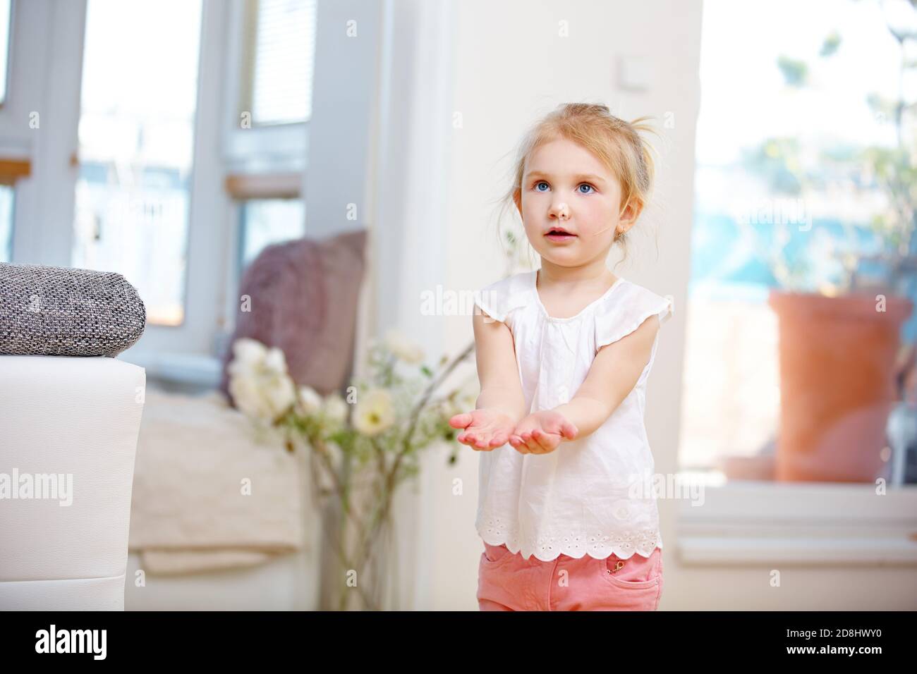 Small child holds hands to catch while playing at home Stock Photo - Alamy