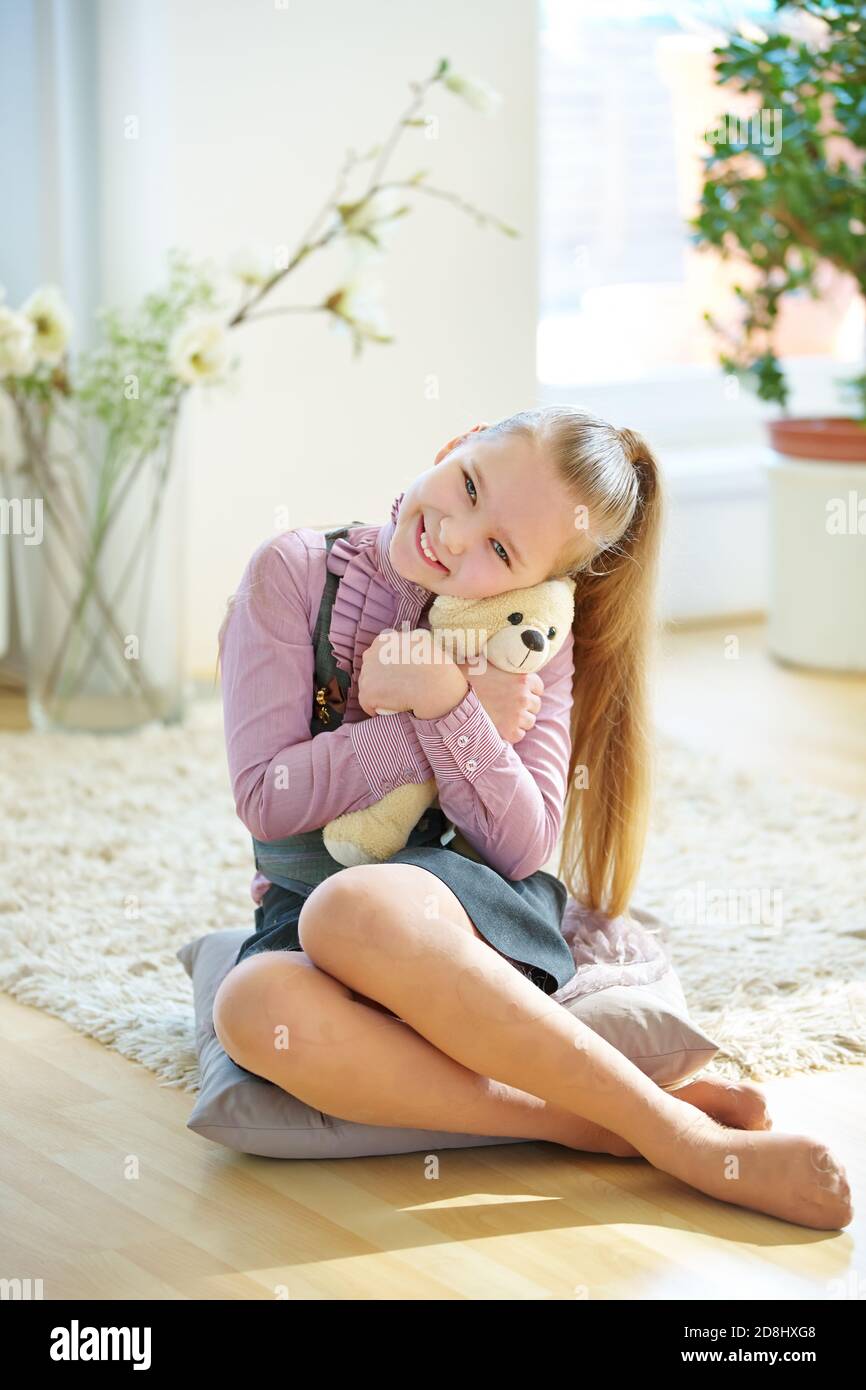 Girl cuddles with her cuddly toy at home Stock Photo - Alamy