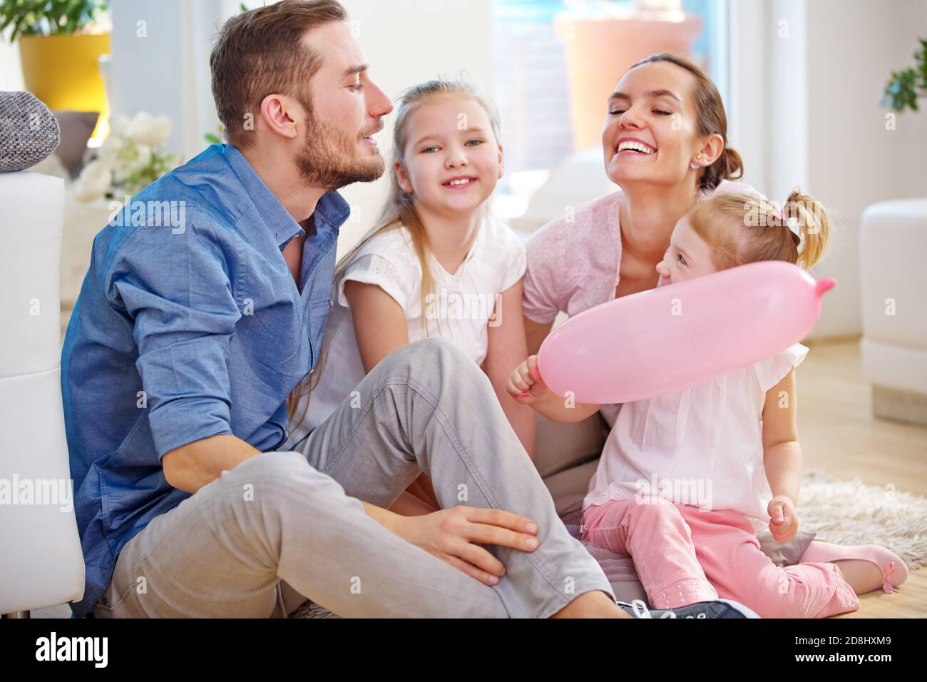 Happy family with two children is sitting at home in the living room ...