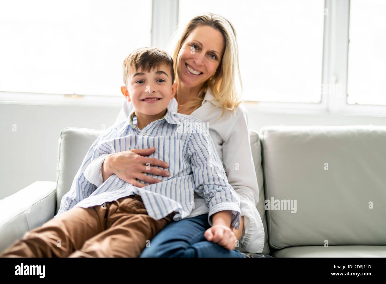 people and family happy boy with mother on sofa at home Stock Photo - Alamy