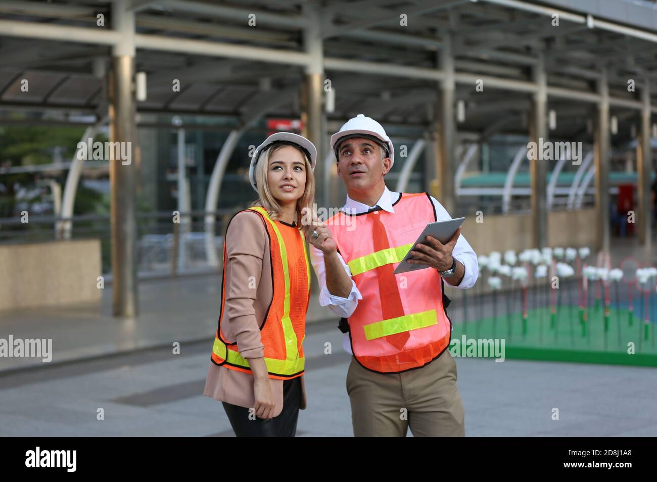 Female industrial engineer wearing a white helmet while standing in a ...