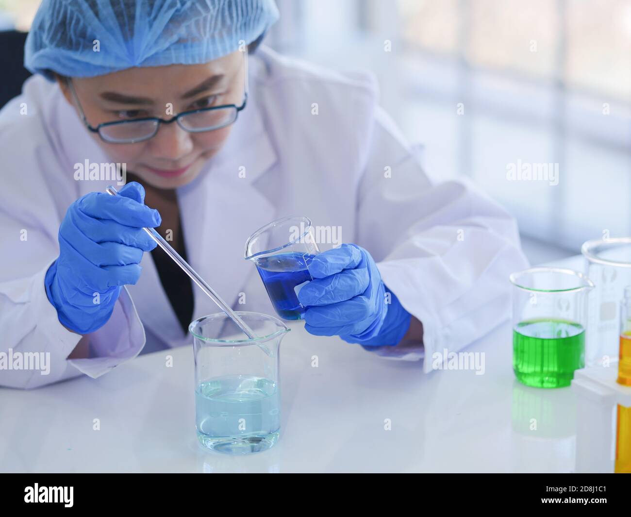 Senior female scientists working alone in the lab Preparing to mix the ...