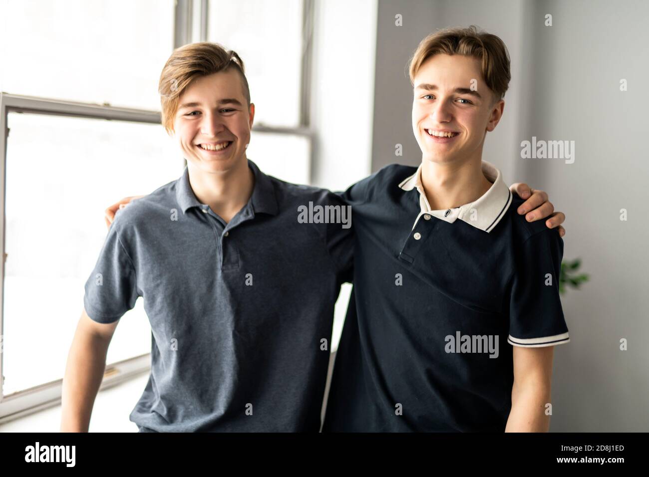 Two happy friends portrait inside house happy Stock Photo - Alamy