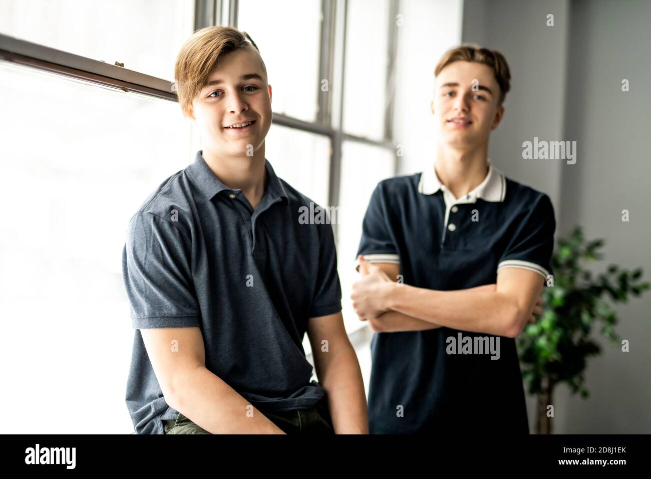 Two happy friends portrait inside house happy Stock Photo - Alamy