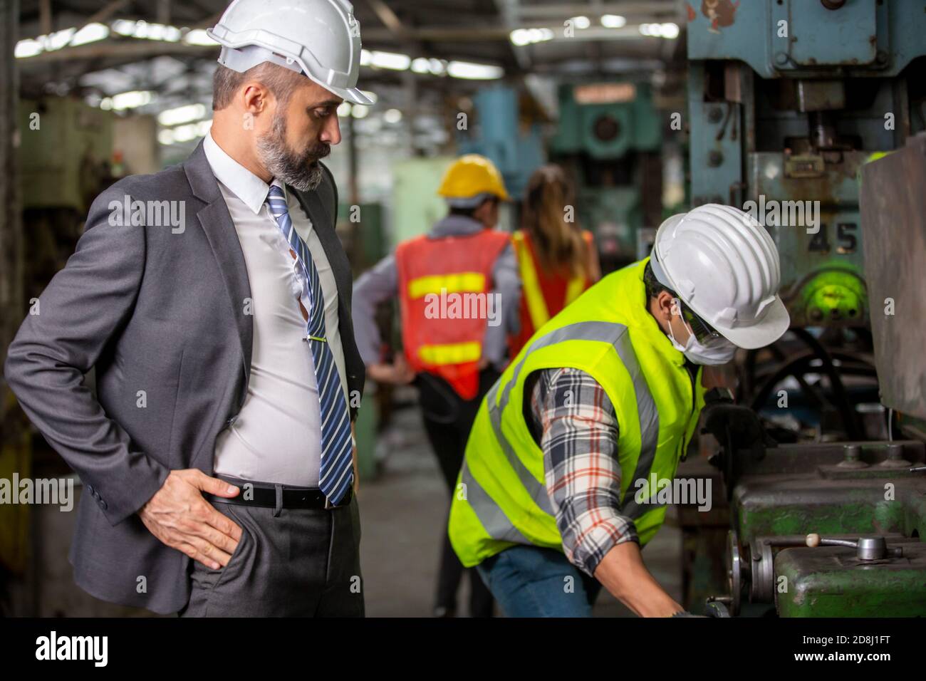 Male Industrial Engineers Talk with Factory Worker . They Work at the ...
