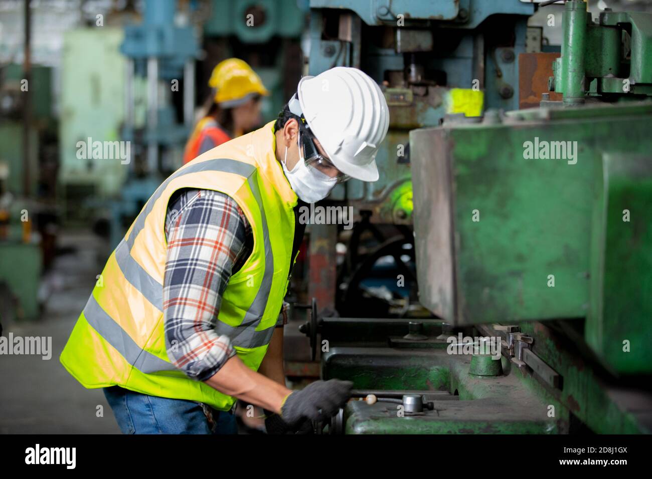 Engineers operating a cnc machine in factory Stock Photo - Alamy
