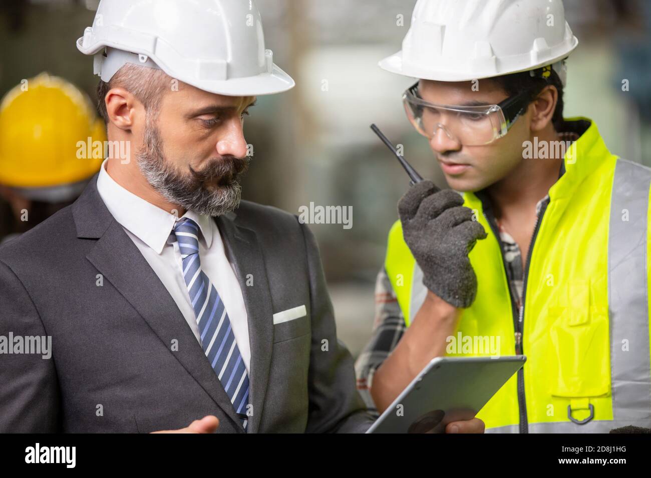 Male Industrial Engineers Talk with Factory Worker . They Work at the ...