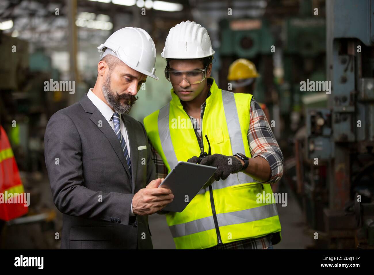 Male Industrial Engineers Talk with Factory Worker . They Work at the ...