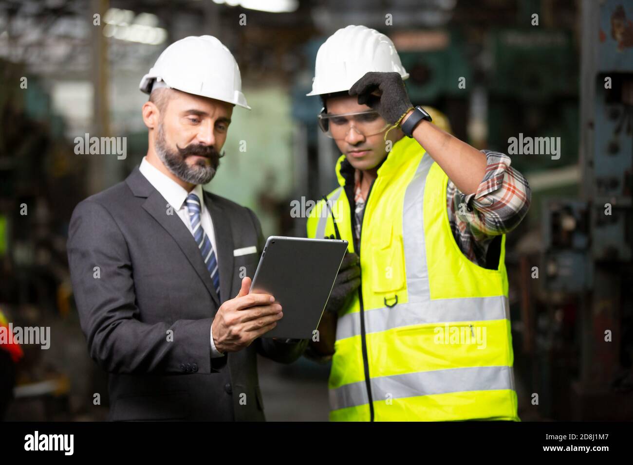 Male Industrial Engineers Talk with Factory Worker . They Work at the ...