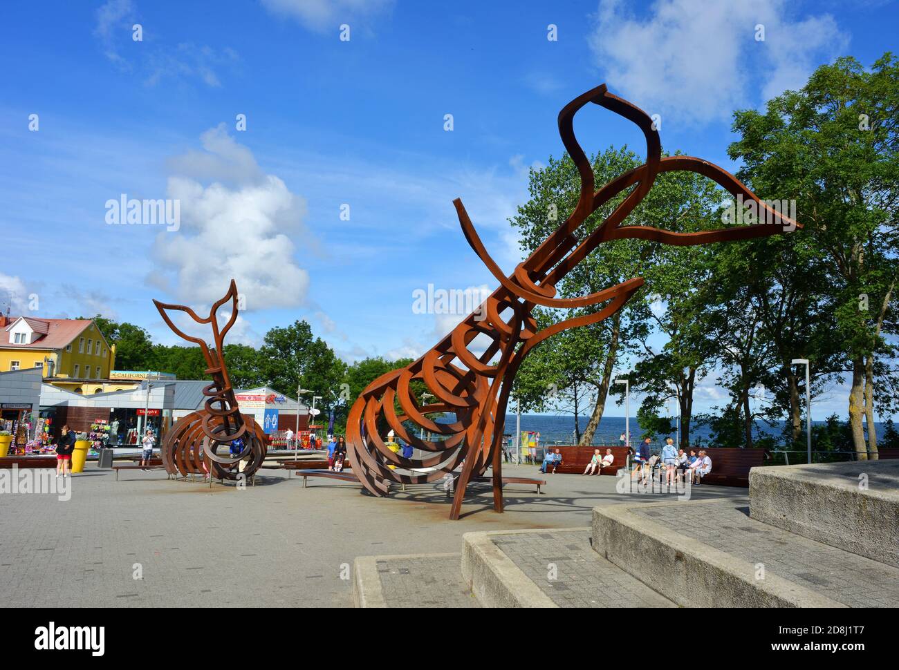 Rewal, Poland, village center, sculptures of whale fish, view to the ...