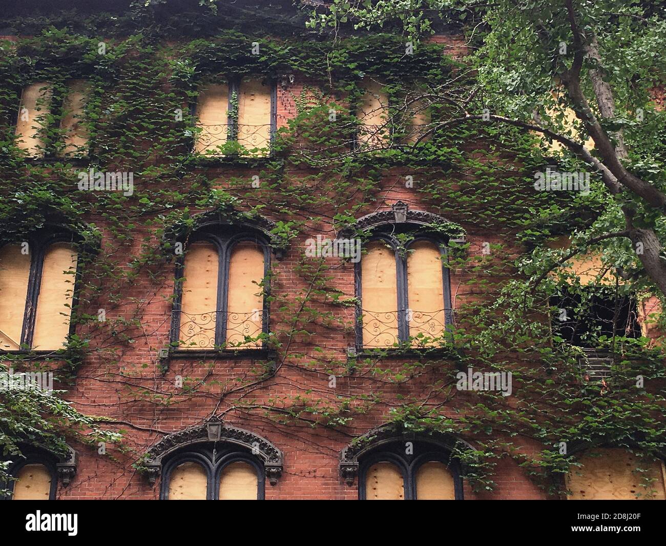 Building with Boarded up Windows Stock Photo - Alamy