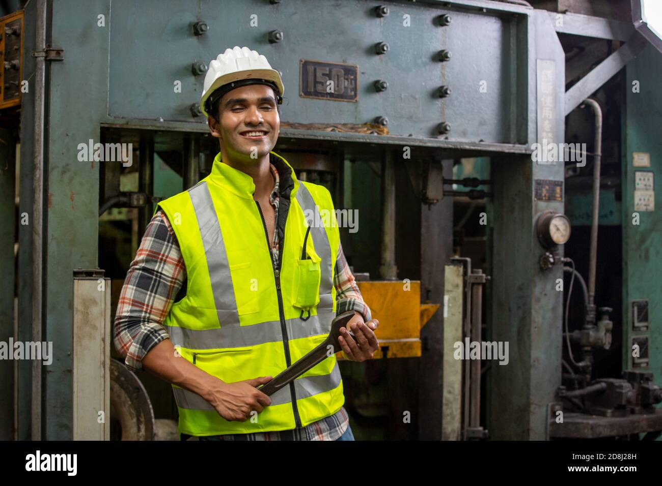 Engineers operating a cnc machine in factory Stock Photo - Alamy