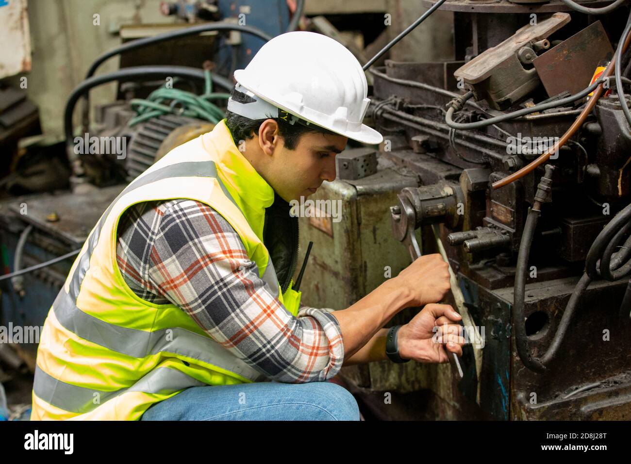 Engineers operating a cnc machine in factory Stock Photo - Alamy