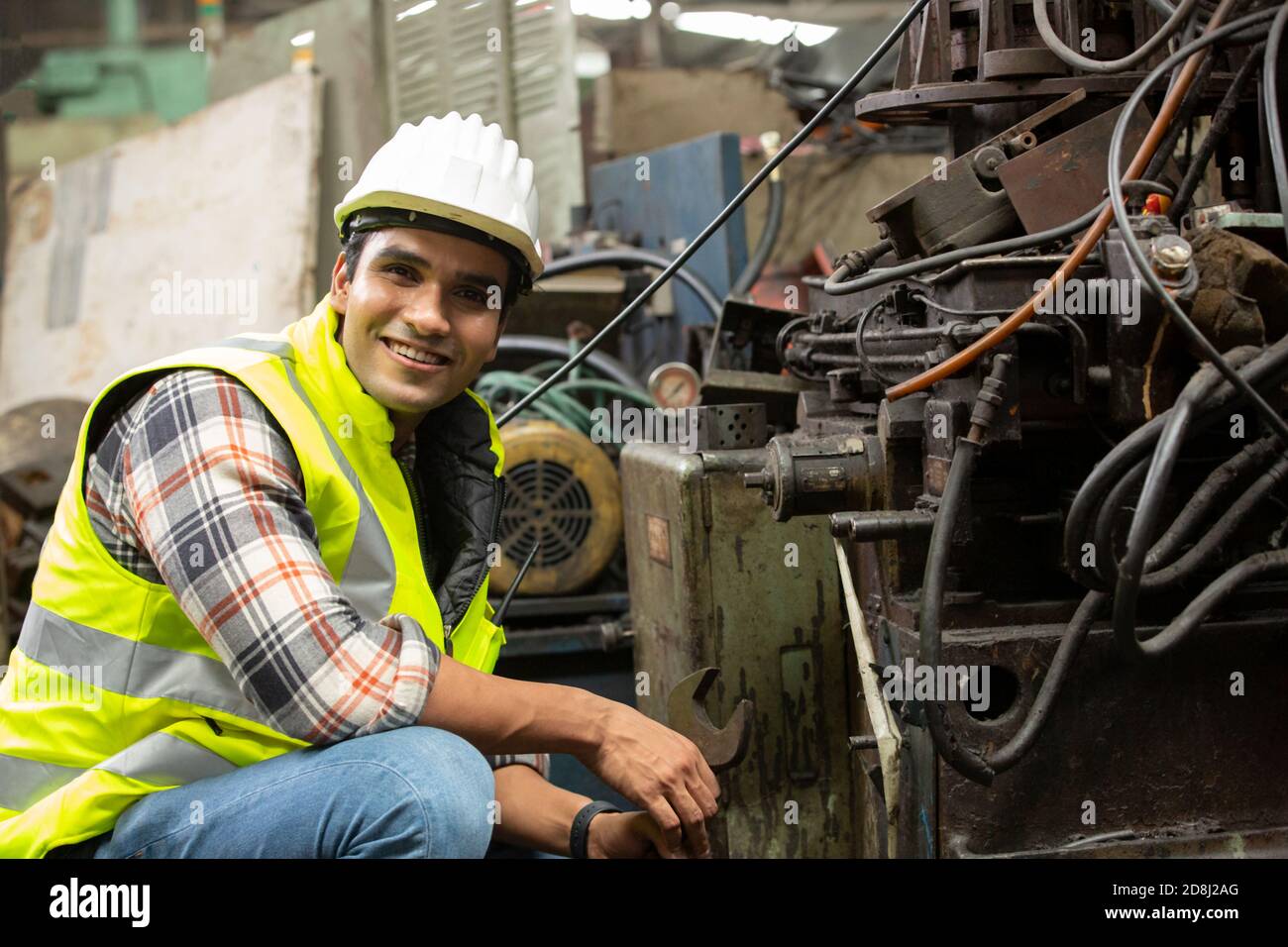 Engineers operating a cnc machine in factory Stock Photo - Alamy