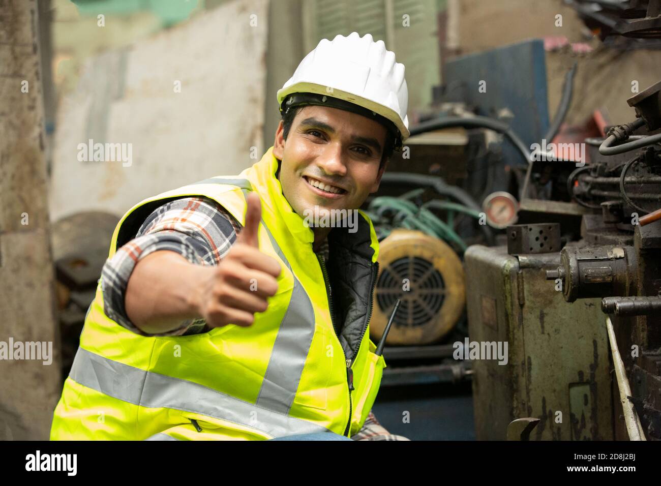 Engineers operating a cnc machine in factory Stock Photo - Alamy